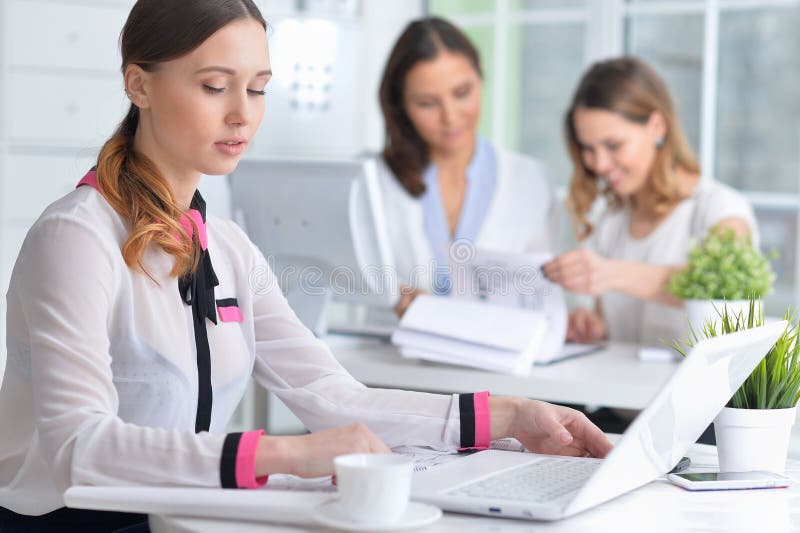 Young Women Sit at the Table and Work in a Modern Office Stock Photo ...