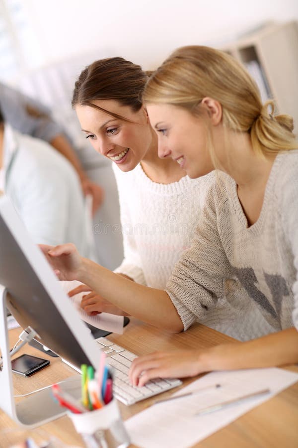 Young Women Working on Desktop Computer Stock Photo - Image of group ...