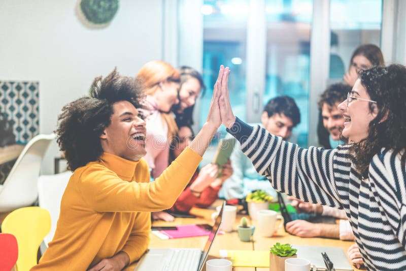 Happy Multicultural Office Workers Laughing Having Fun Riding On Chairs