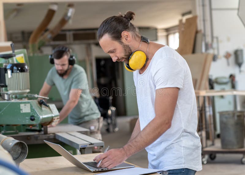 Young Worker in a Carpenter`s Workshop Using Milling Machine Stock ...