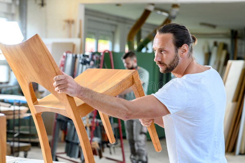 Young Worker in a Carpenter`s Workshop with Wooden Chair Stock Photo ...
