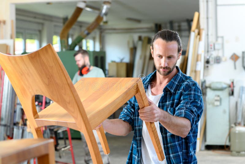 Young Worker in a Carpenter`s Workshop with Wooden Chair Stock Image ...