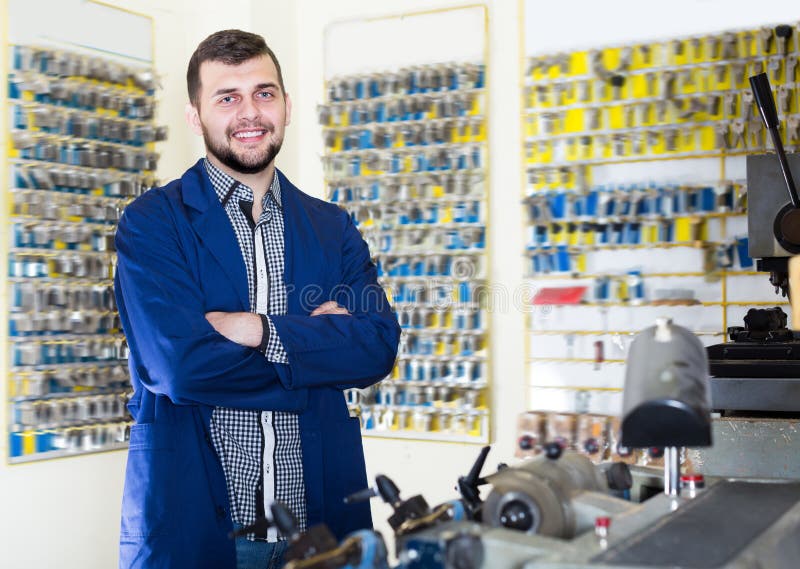 Young Worker Demonstrating Tools for Making Keys Stock Photo - Image of ...