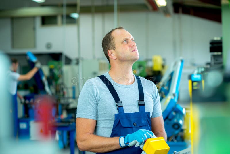 Young worker in factory stock image. Image of machine - 47870495