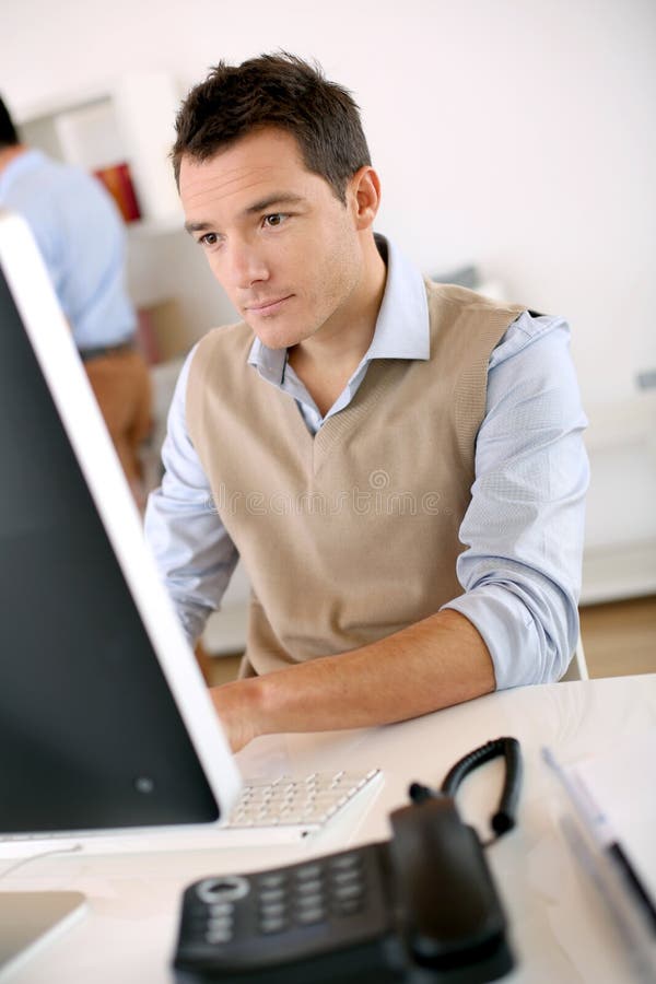 Young Worker in Front of Computer Stock Photo - Image of worker ...