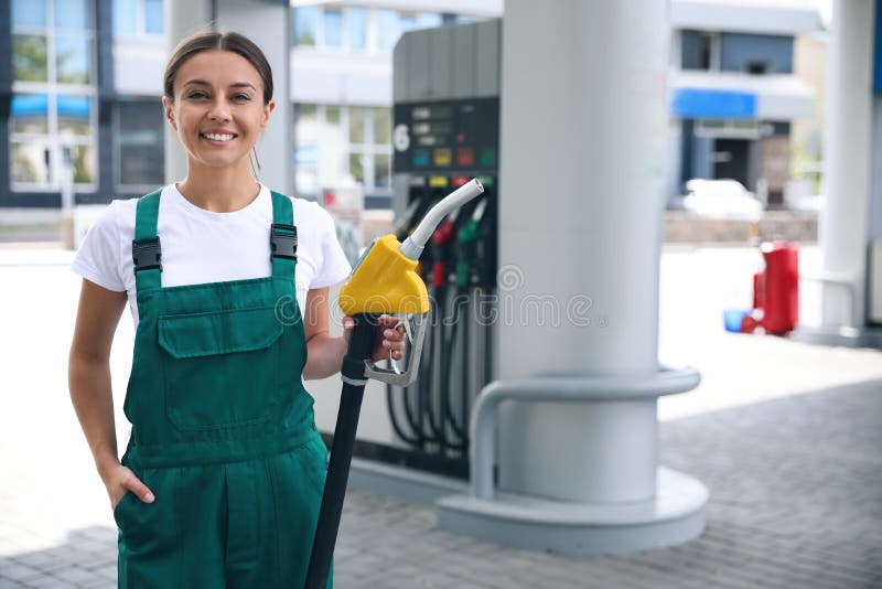 Young Worker with Fuel Pump Nozzle at Modern Gas Station Stock Photo ...