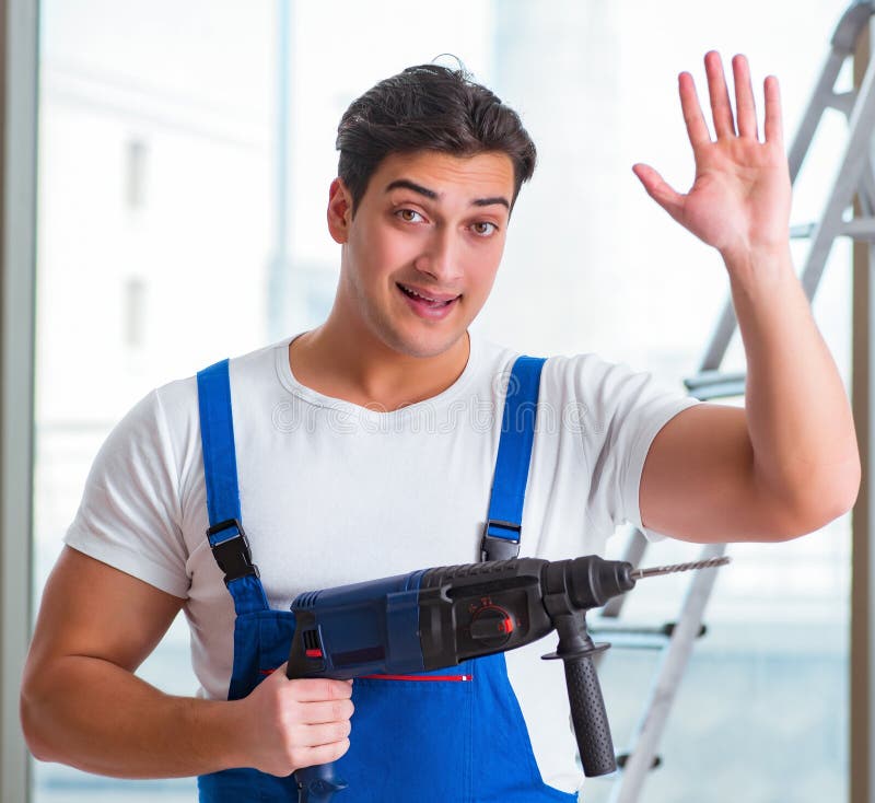 Young Worker with Hand Drill Stock Photo - Image of equipment, male ...
