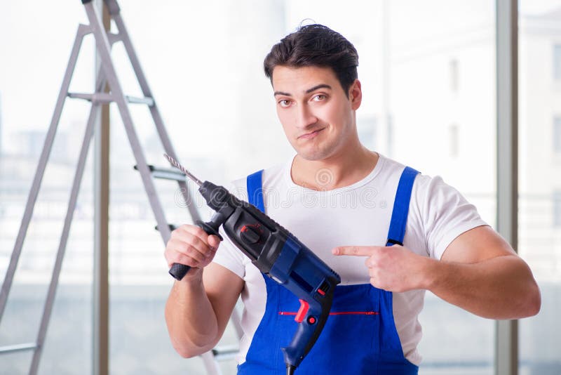 The Young Worker with Hand Drill Stock Image - Image of hammer, hardhat ...