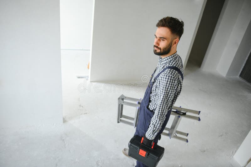 Young Worker Making Repair in Room Stock Photo - Image of equipment ...