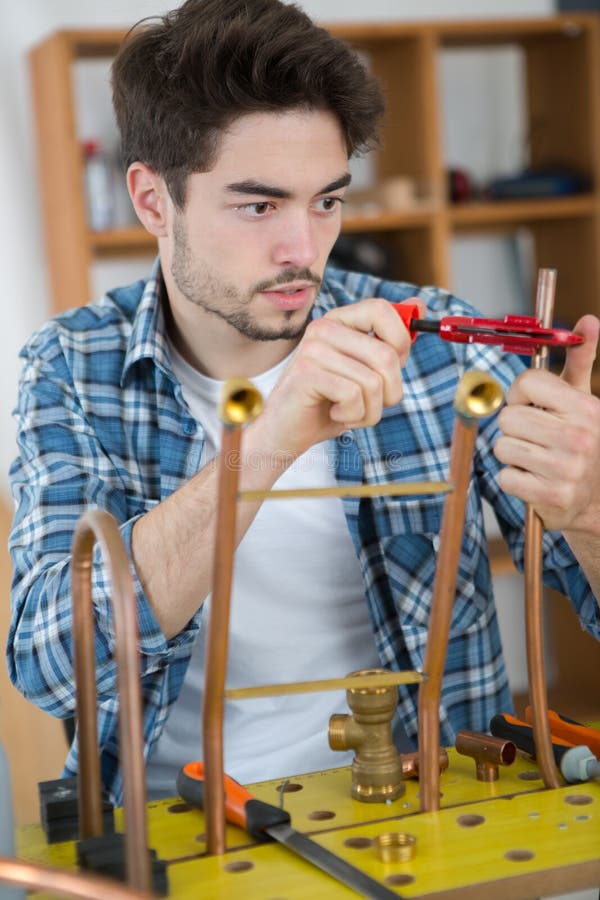 Young Worker with New Copper Pipes Stock Image - Image of industry ...