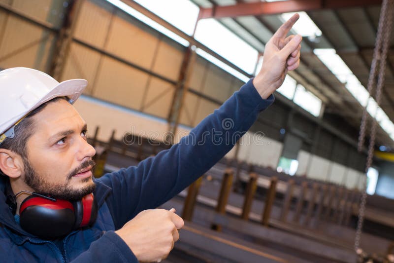 Young Worker Pointing in Factory Stock Image - Image of factory ...