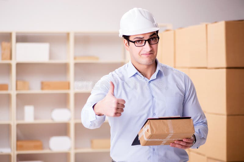 The Young Worker in the Postal Office Dealing with Parcels Stock Photo ...