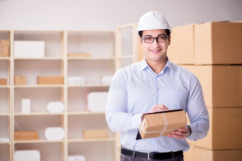 The Young Worker in the Postal Office Dealing with Parcels Stock Photo ...