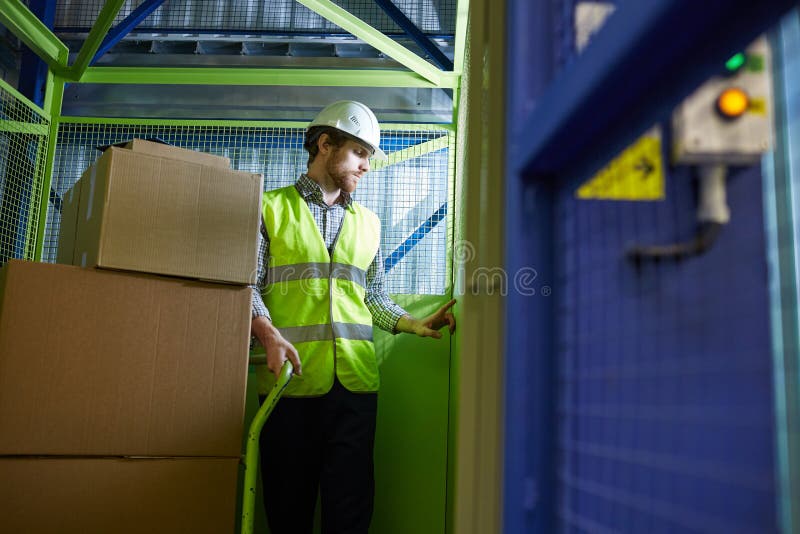 Worker with load in lift stock image. Image of clipboard - 171899023