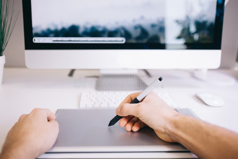Young Worker Sitting in an Office at the Computer. Freelancer in a Blue ...