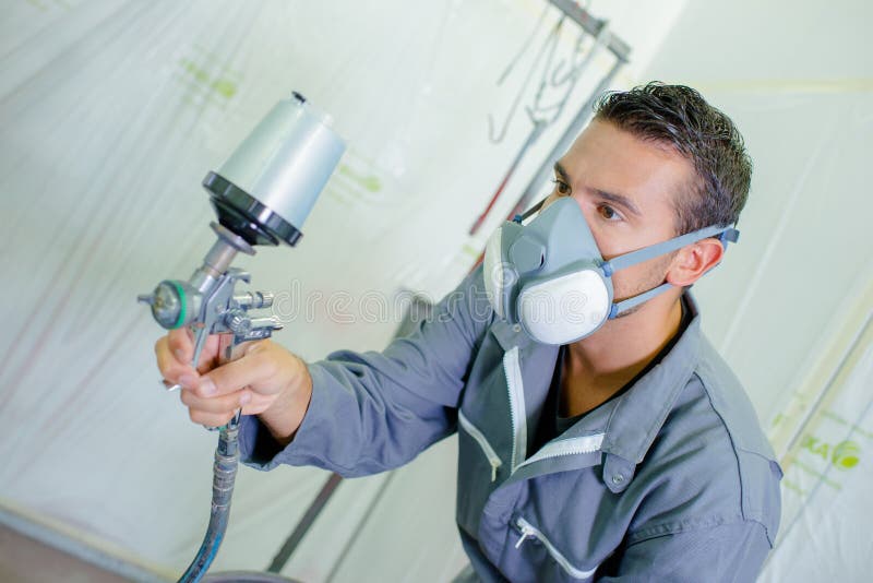 Young worker using pistol stock photo. Image of renewal - 102659746