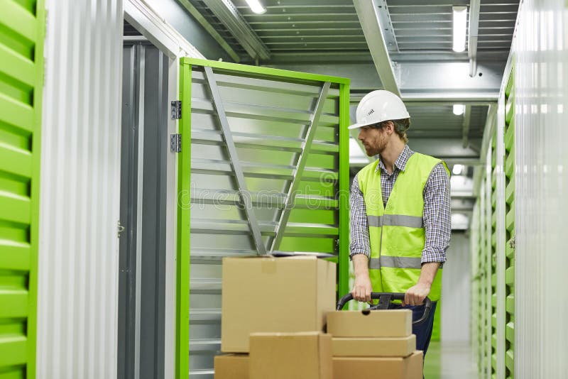 Man Loading Boxes in Warehouse Stock Photo - Image of uniform, service ...