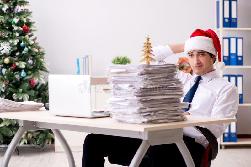 The Young Worker Working in Office on Christmas Shift Stock Photo ...