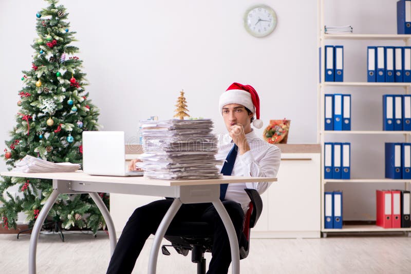 The Young Worker Working in Office on Christmas Shift Stock Photo ...
