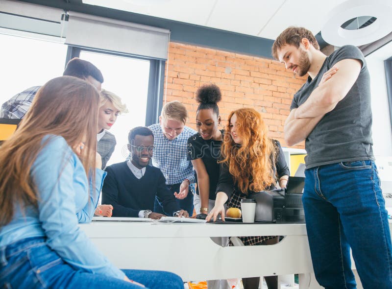 Young Workers Controlling the Work of Their New Collegue Stock Image ...