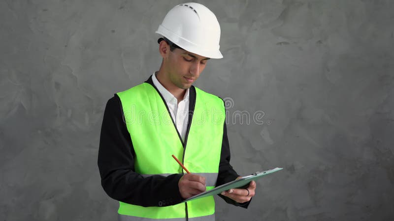 Young Working Arab Civil Engineer Using a Tablet Planning a Project ...