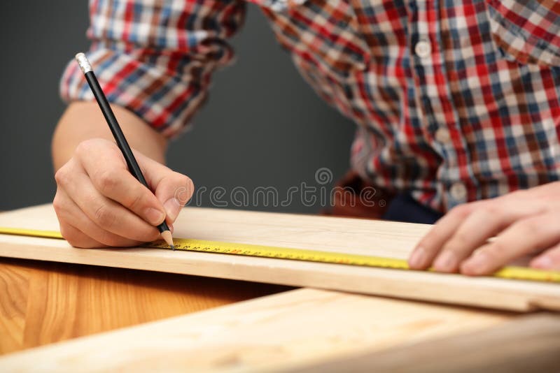Young Working Man Making Marks on Timber Indoors. Home Repair Stock ...