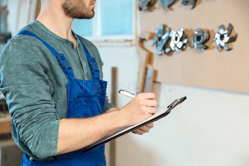 Young Working Man in Uniform Making Notes Stock Photo - Image of making ...