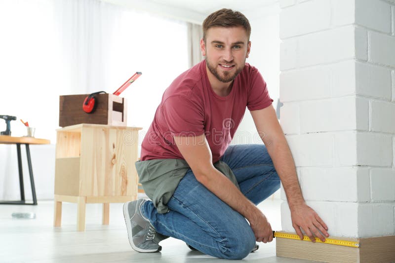 Young Working Man Using Measure Tape at Home Stock Photo - Image of ...