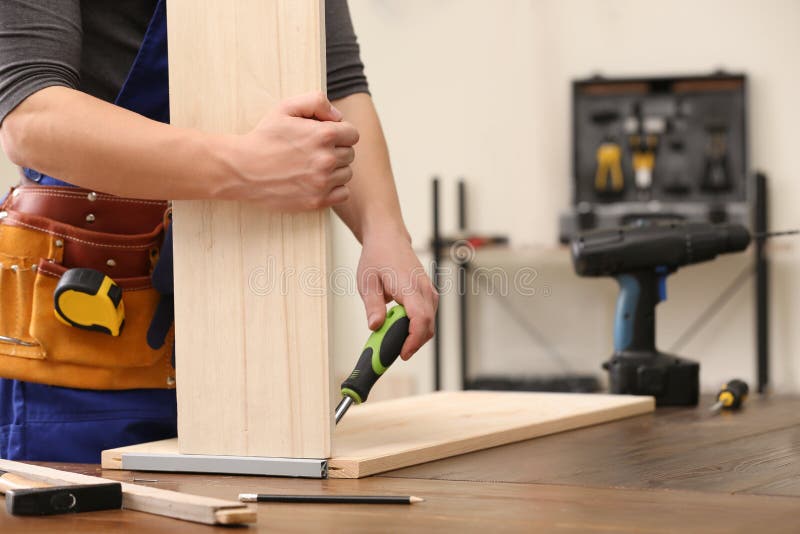 Young Working Man Using Screwdriver Indoors, Closeup. Home Repair Stock ...