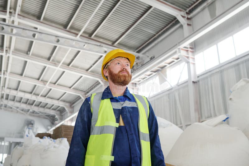 Young Workman in Uniform and Yellow Hardhat Moving Along Spacious ...