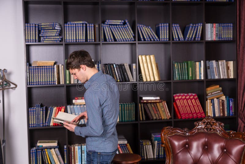 Young Young Man Scanning a Book at the Library Stock Image - Image of ...