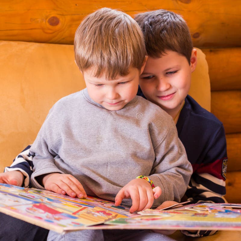 Younger Brother Learning To Read Stock Photo - Image of cute, home ...