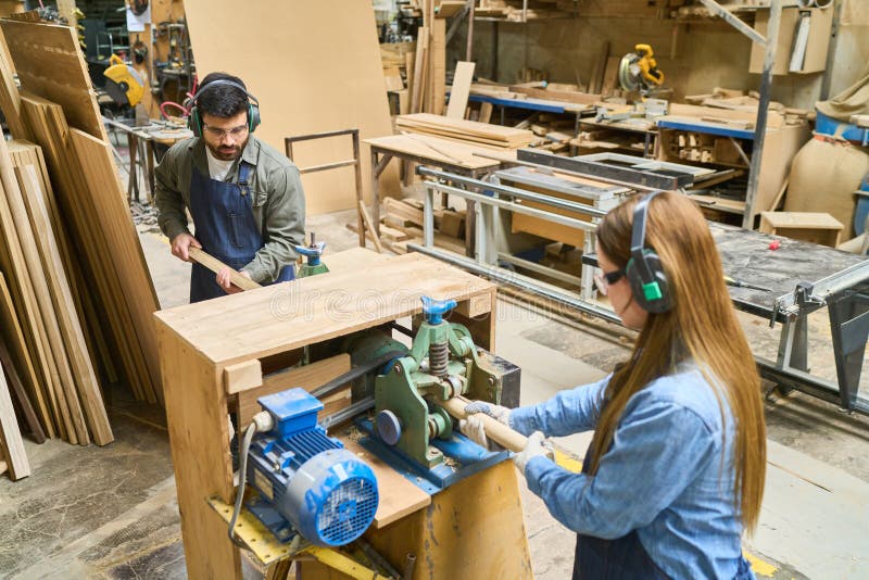 Young and Older Workers Collaborating in a Busy Lumberyard Stock Image ...