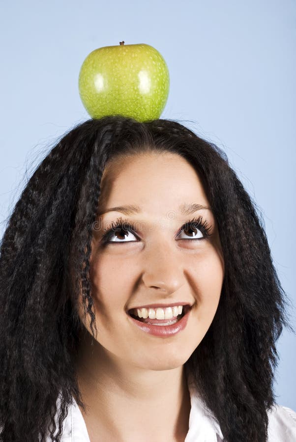 Young Woman Eating a Green Apple Stock Photo - Image of apple, indoors ...