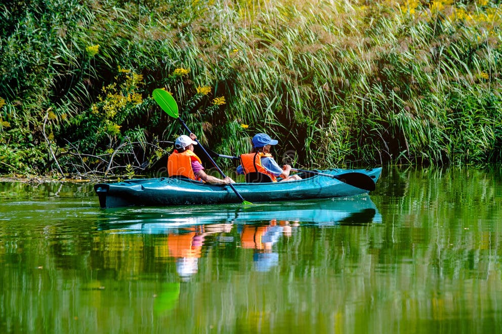 Youth floating in a canoe stock photo. Image of canoe - 365971734