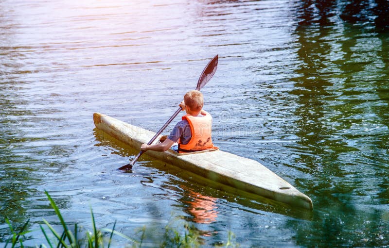 Youth floating in a canoe stock photo. Image of kayaking - 211642620