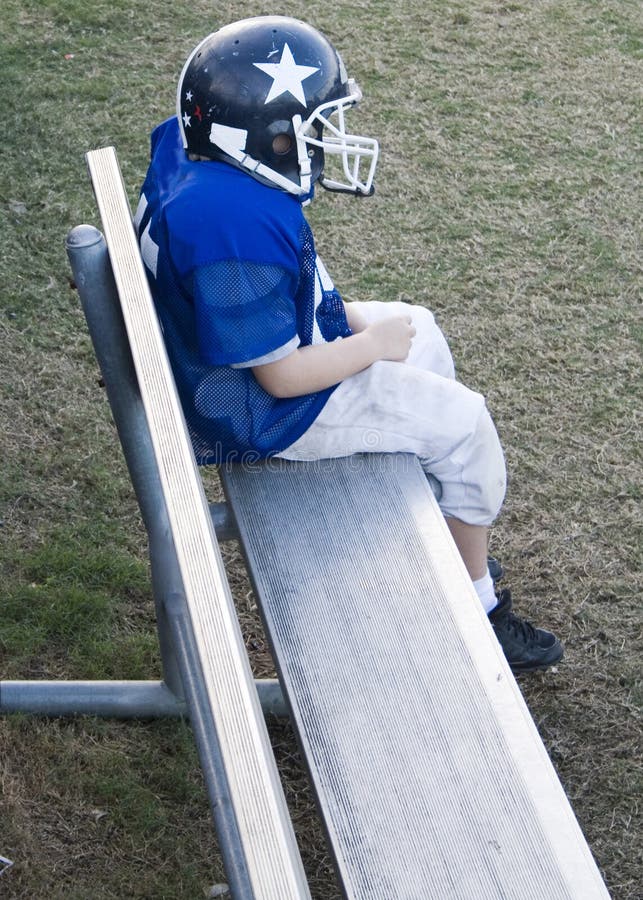 Youth Football Player Alone on the Bench Stock Image - Image of child ...