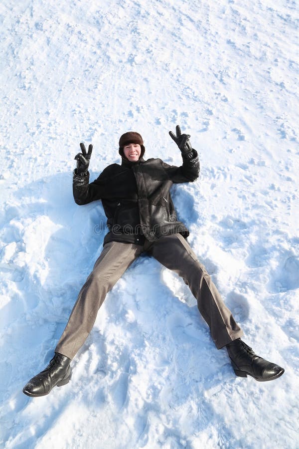 Youth Lies on Snow on Back and Shows Hands Gesture Stock Image - Image ...