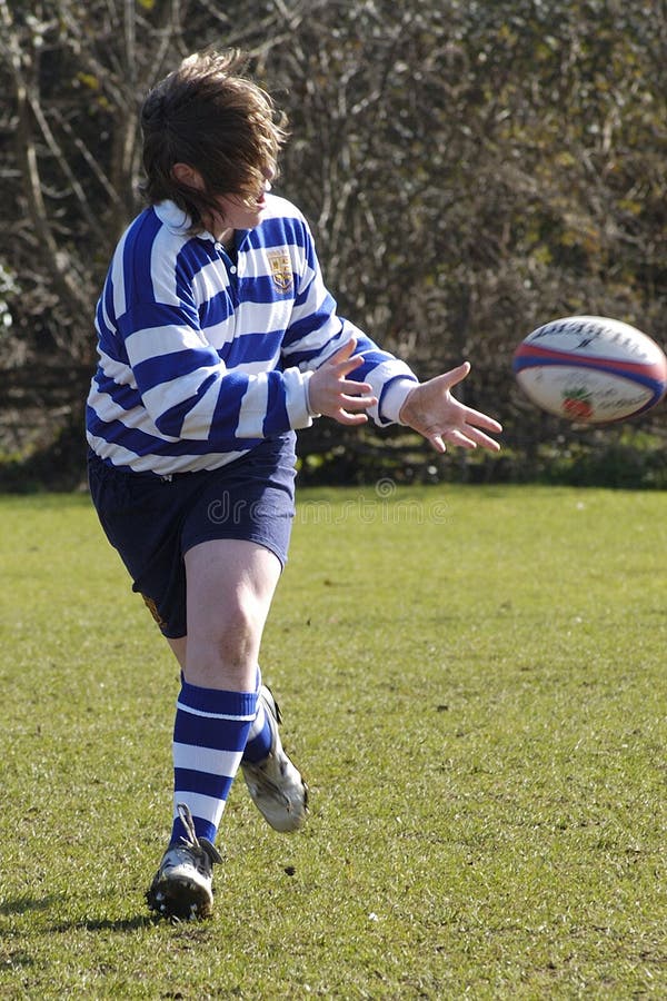 A Youth Rugby Player Passing a Rugby Ball !! Stock Photo - Image of ...