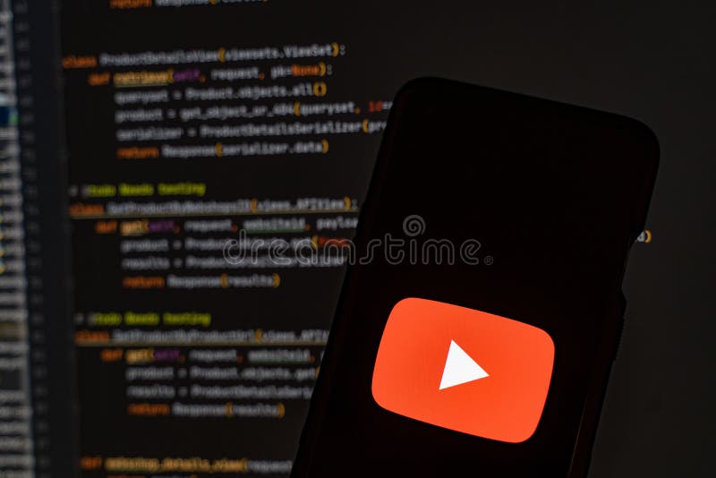 Youtube App on a Phone in Front of a Screen with Code on it Editorial ...