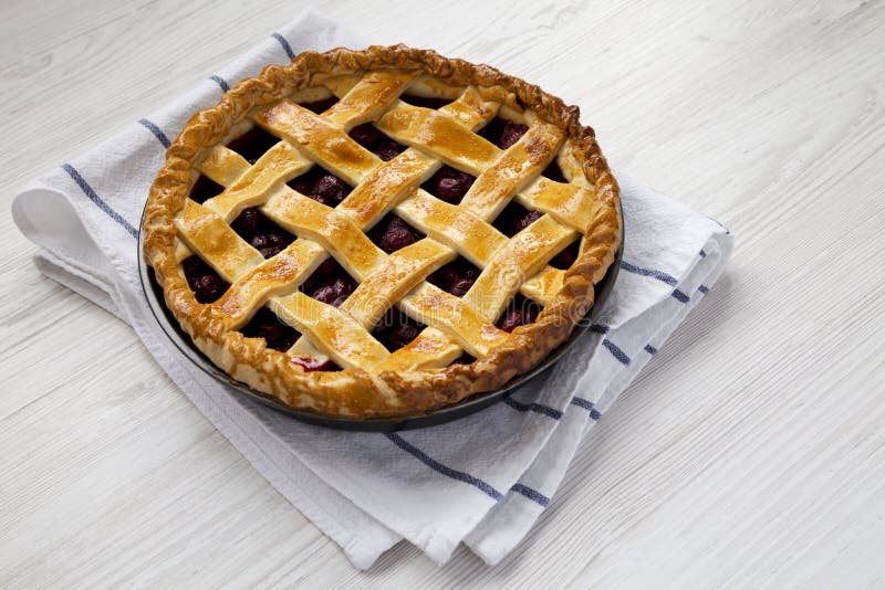 Yummy Homemade Cherry Pie on a White Wooden Table, Side View. Space for ...