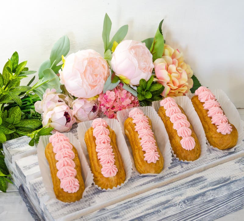 Yummy Vanilla Eclairs on Wood with Flower Decoration Stock Image ...