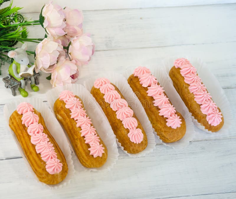 Yummy Vanilla Eclairs on Wood with Flower Decoration Stock Image ...