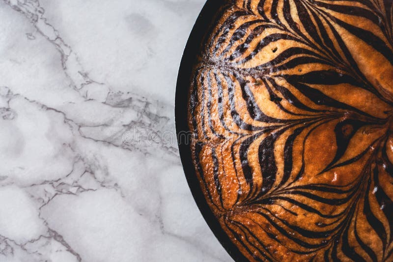 Zebra Cake Placed on a White Marble Tabletop in a Cake Pan, High-angle ...