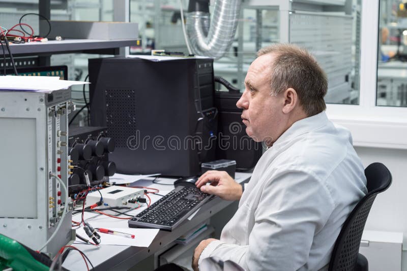 The Engineer Conducts a Test of the Finished Electronic Modules ...