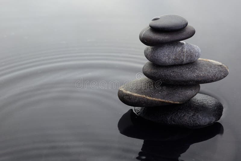 Zen Stones in Balanced Pile in Water on Rippled Water Surface. Stock ...