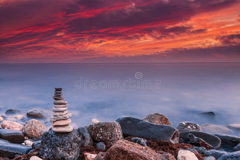 Zen Sunset by the Sea. Stack of Stones. Stock Image - Image of pink ...