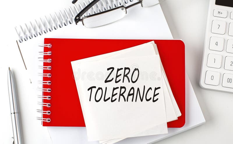 ZERO TOLERANCE Word on the Sticker on Notepad with Pen and Calculator ...