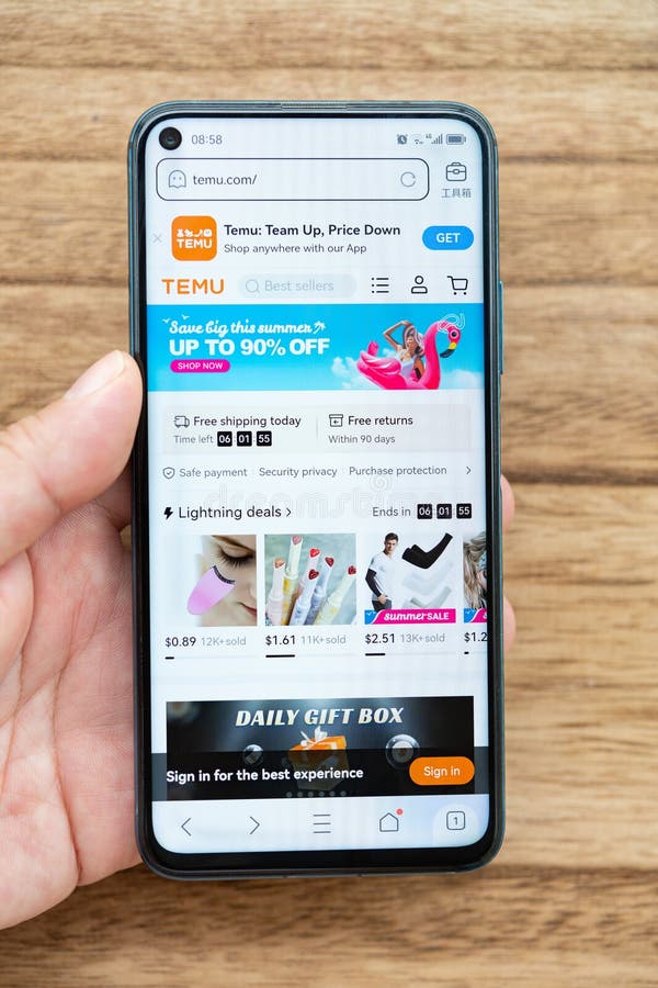 A Mobile with Temu Logo in a Shopping Cart Model at Vertical ...