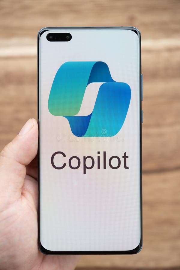 Hand Holding a Mobile with Copilot Logo at Vertical Composition ...